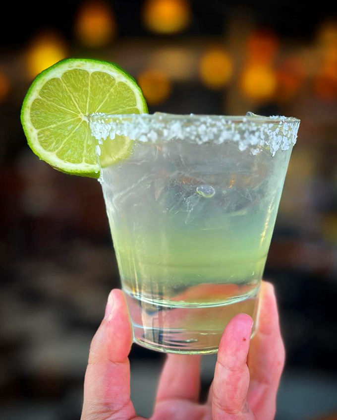 The salt-rimmed margarita glass—nature's way of saying "the weekend starts now." That lime wedge isn't just garnish, it's an exclamation point.