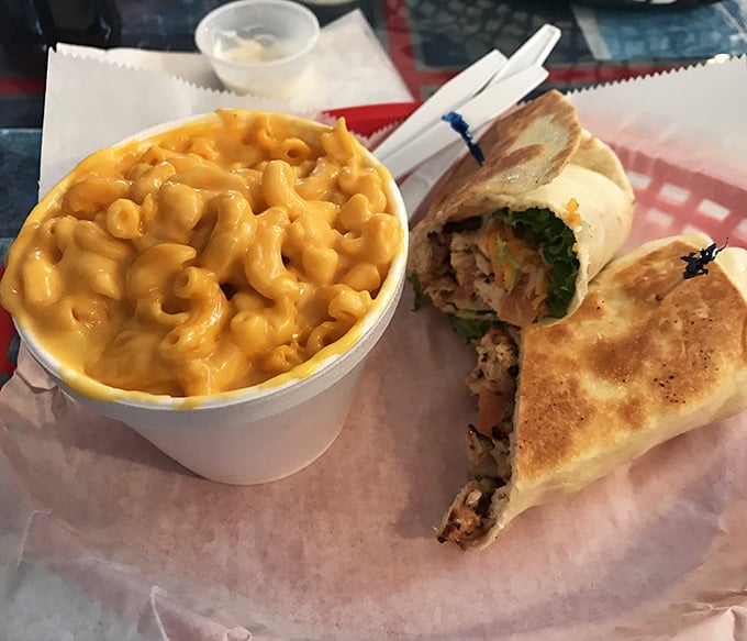 Mac and cheese so vibrant it could direct traffic, paired with a wrap that's holding more delicious secrets than a small-town gossip. 