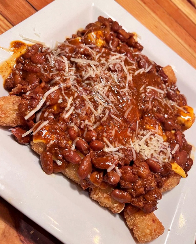 Tater tots elevated to an art form&mdash;smothered in chili, cheese, and hope. Comfort food that hugs your soul from the inside.