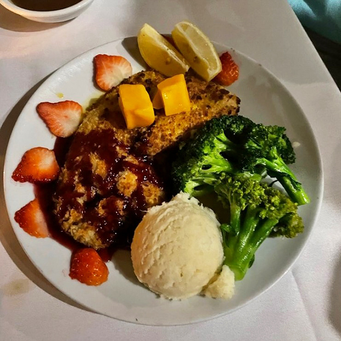 This isn't just fish&mdash;it's a tropical vacation on a plate. Mango-topped macadamia-crusted mahi with sides that know their role in this delicious ensemble.