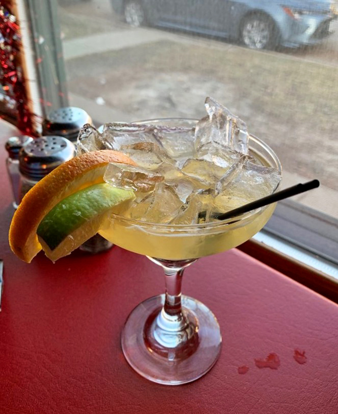 A perfectly mixed margarita with fresh citrus waiting at the bar. Because great pizza deserves equally impressive liquid companionship.