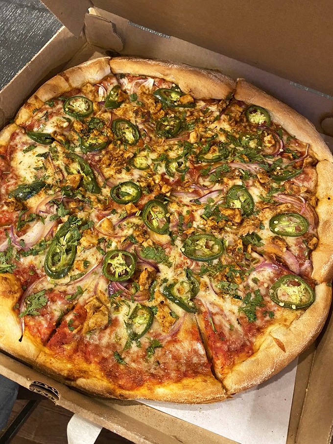 A pizza that looks like it flew business class from Mumbai to Naples. The vibrant colors alone tell you this isn't your standard delivery fare.