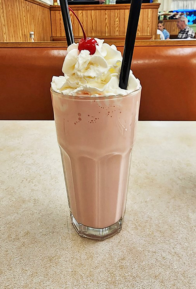 This isn't just a strawberry shake&mdash;it's a frothy pink promise of happiness topped with whipped cream and childhood memories.