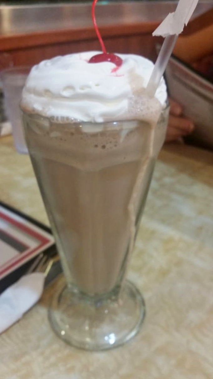 This isn't just a milkshake&mdash;it's a frothy tower of happiness topped with whipped cream and a cherry sentinel.