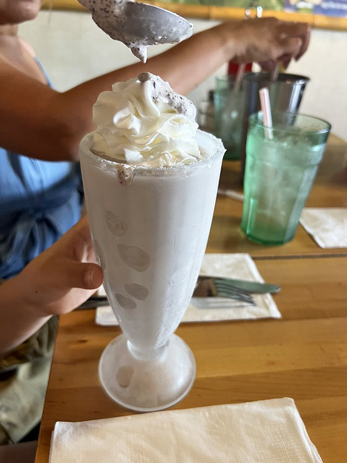 This isn't just a milkshake &ndash; it's a tower of creamy nostalgia topped with enough whipped cream to make your inner child high-five your adult self.