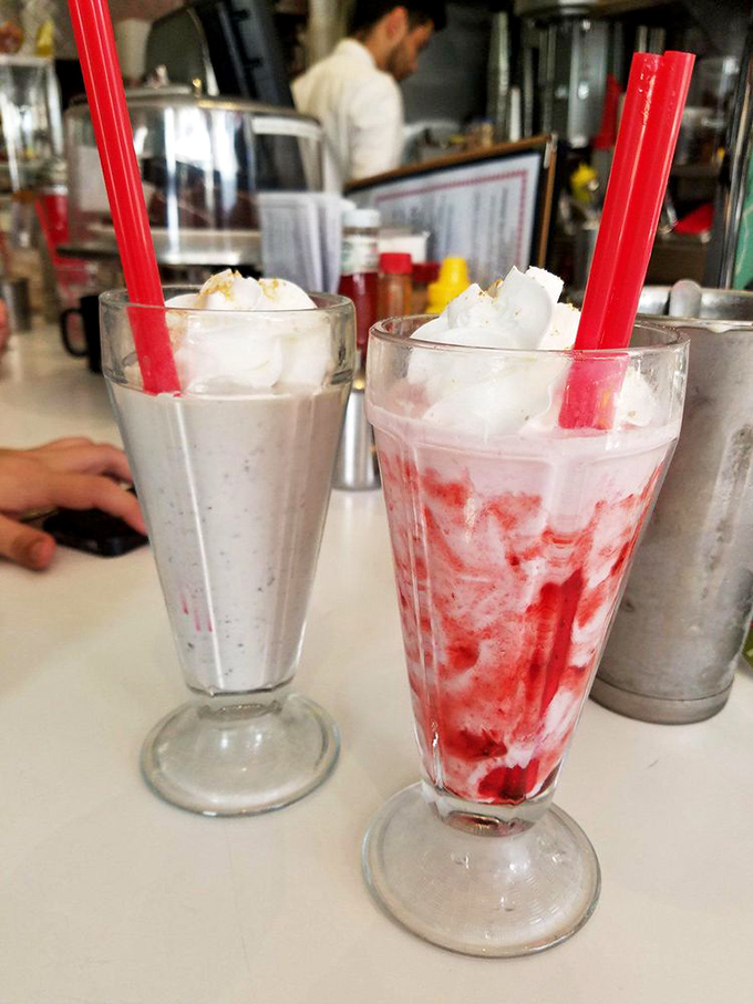 Milkshakes so thick they're practically standing at attention. One strawberry, one cookies-and-cream, both requiring serious straw commitment and zero regrets.