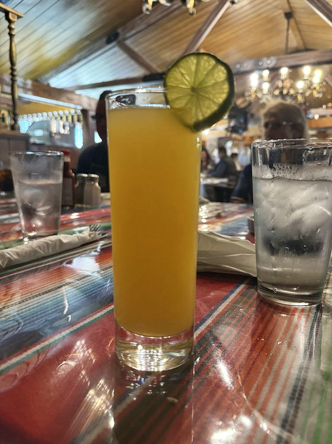 A sunshine-yellow cocktail garnished with lime &ndash; liquid California in a glass, perfect for toasting good company in wood-paneled splendor.