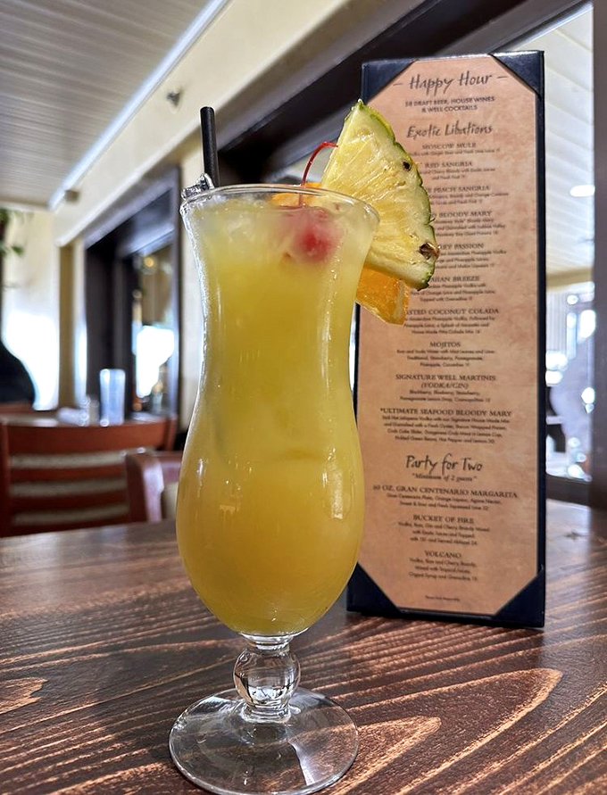 This isn't just a tropical drink—it's liquid sunshine in a glass, complete with a pineapple slice that's basically wearing a tiny vacation hat.
