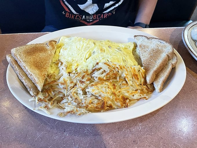 This omelet has achieved that perfect golden hue that says "good morning" better than any alarm clock ever could. Hash browns crispy enough to make a statement.