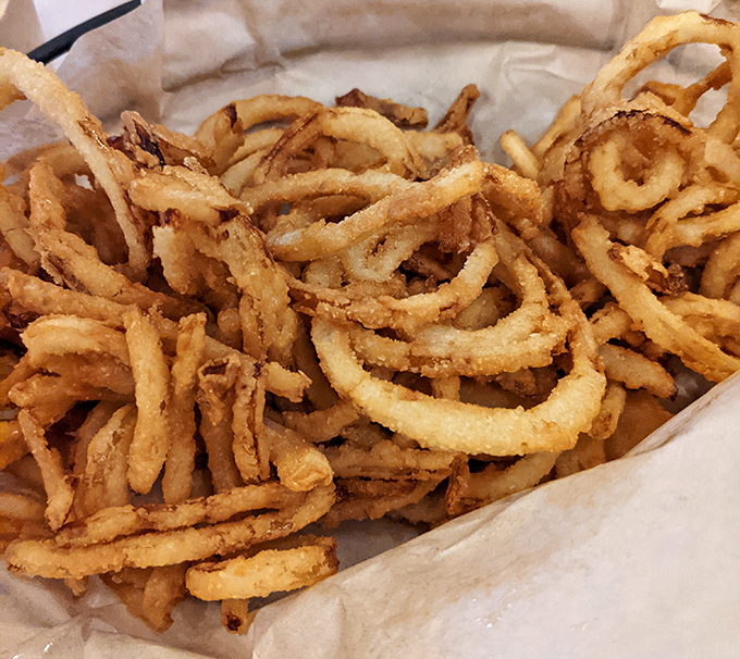 These aren't just onion rings; they're crispy, golden halos of happiness that crunch loud enough to turn heads three tables away.