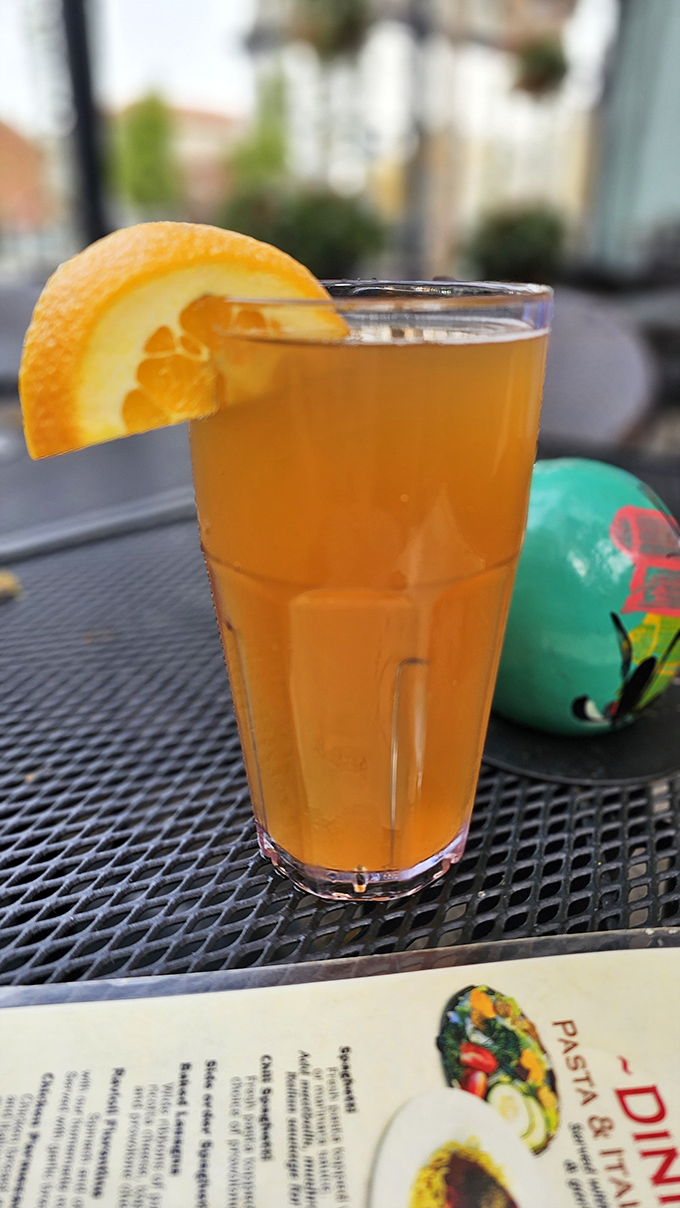 That refreshing orange-garnished beverage isn't just a drink &ndash; it's a pause button for life's chaos, especially when enjoyed on Ron's patio on a warm Ohio afternoon.