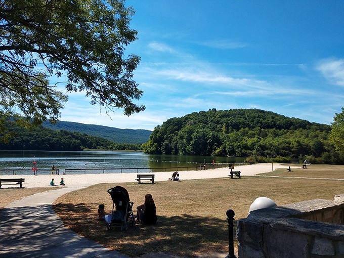 The beach area where kids build sandcastles while parents pretend they're not secretly planning to build their own. Lake views included at no extra charge.