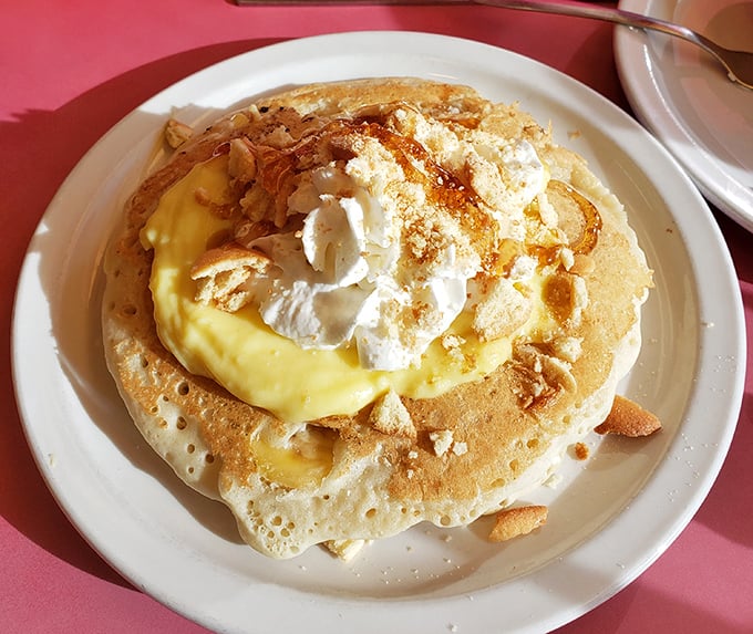 This isn't just a pancake&mdash;it's a canvas for culinary joy, topped with cream and what appears to be lemon curd. Breakfast as art form.