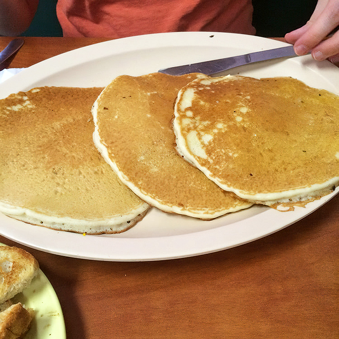 Pancakes so perfectly golden they belong in a breakfast hall of fame. The kind that make you forget about your diet until tomorrow.