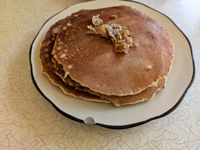 Pancakes so perfectly golden they make you wonder if the griddle has been seasoned with decades of breakfast memories.
