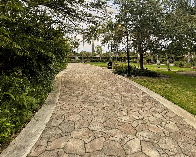 Winding stone pathways lead visitors through lush gardens, building anticipation for the colossal sculpture ahead.