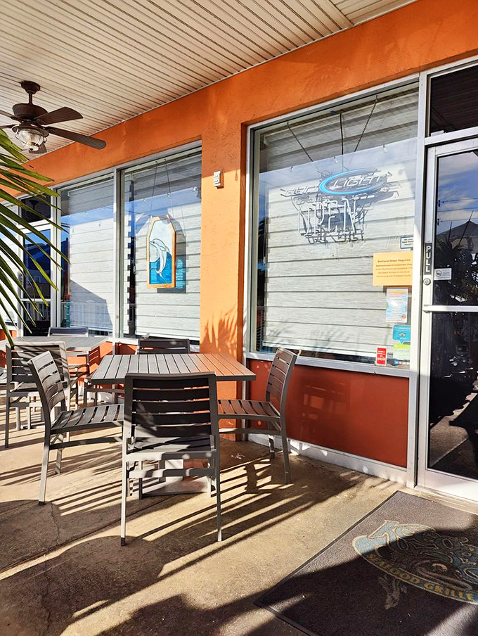 The sun-drenched patio where salt air seasons every bite and palm shadows dance across your table.