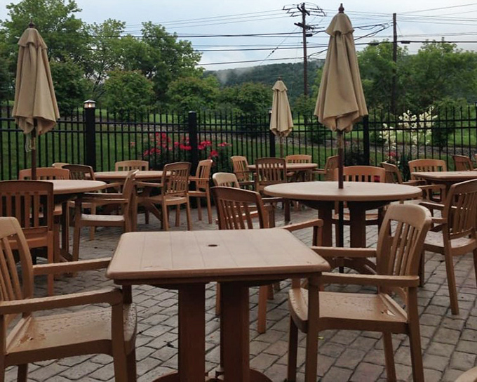 The outdoor patio invites lingering conversations and lazy summer evenings. These tables have hosted everything from first dates to retirement celebrations.