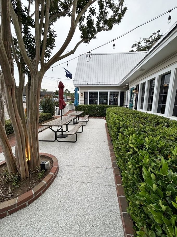 The outdoor seating area offers a peaceful retreat among manicured shrubs. Nature and seafood &ndash; a pairing as old as time itself.