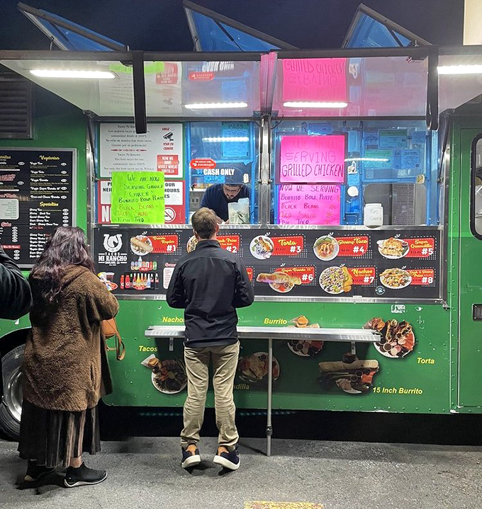 The ordering window buzzes with activity as customers eagerly await their handcrafted Mexican specialties from skilled cooks.