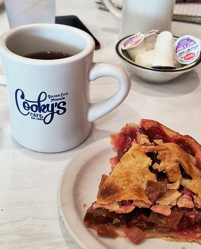 A slice of strawberry-rhubarb alongside Cooky's signature mug&mdash;proof that sometimes the simplest combinations create the most profound happiness.