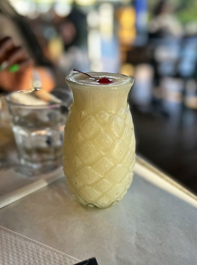 A piña colada in a pineapple-shaped glass – because drinking from regular glassware is so mainland. Vacation in liquid form.