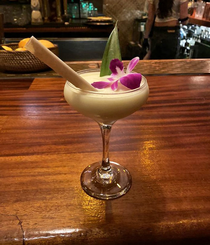 This isn't just a cocktail, it's a vacation in a glass. The flower garnish is basically saying, "Yes, you deserve this moment."