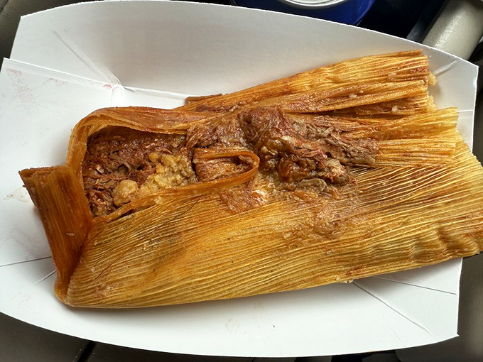 Unwrap this pork tamale like the present it is&mdash;tender meat swimming in rich red sauce, all cradled in perfectly steamed masa. This isn't food; it's an experience.