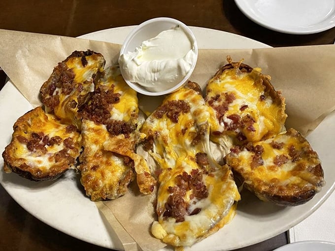 These potato skins aren't just appetizers—they're little boats of happiness sailing on seas of melted cheese and bacon.