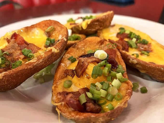 Potato skins loaded with melty cheese, bacon, and green onions—proof that sometimes the best things in life are indeed crispy on the outside, tender inside.