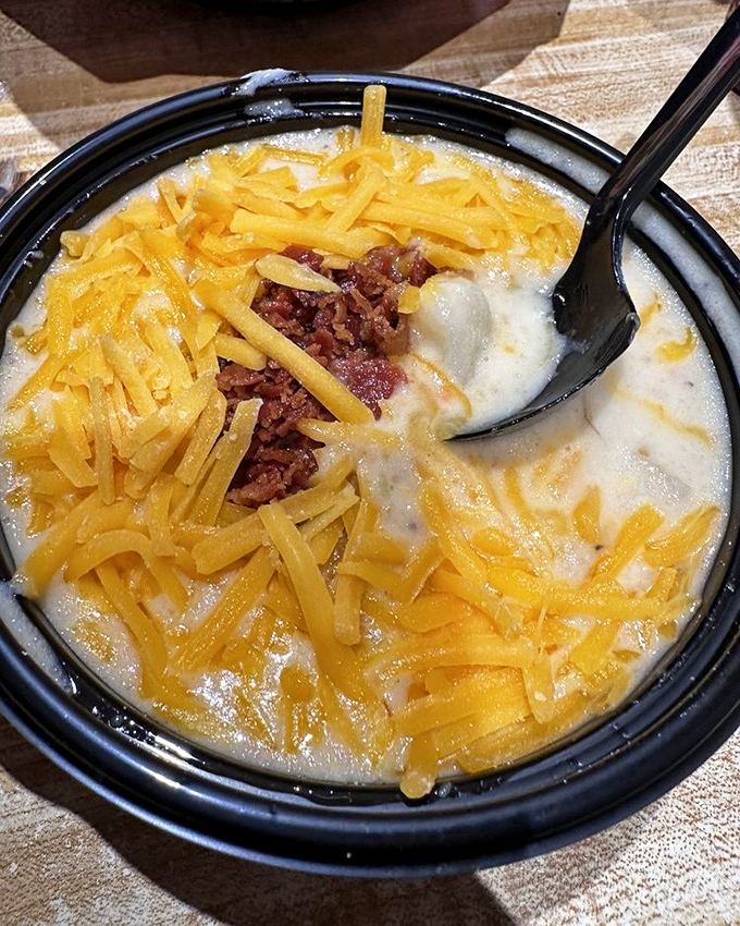 This soup isn't just topped with cheese&mdash;it's wearing a melted cheddar crown. Comfort food royalty in a humble black bowl.