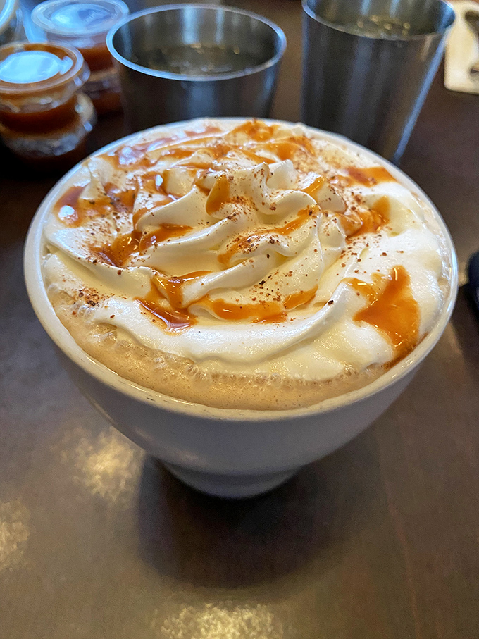 Coffee elevated to an art form: a cloud of whipped cream floating on autumn-spiced heaven, drizzled with caramel that creates hypnotic swirls.