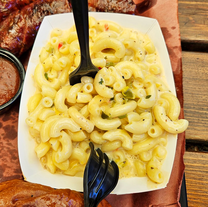 Mac and cheese that doesn't apologize for being exactly what you want – creamy, cheesy, and studded with bits of green chile for that subtle kick.