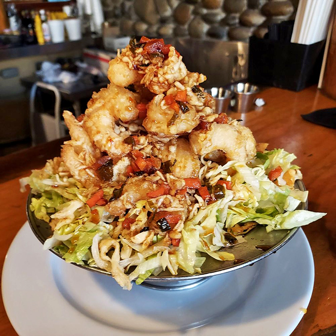 The Railroad Camp Shrimp isn't just food&mdash;it's edible architecture. These golden-fried treasures stacked atop fresh slaw could convert even the most dedicated landlubber to seafood.