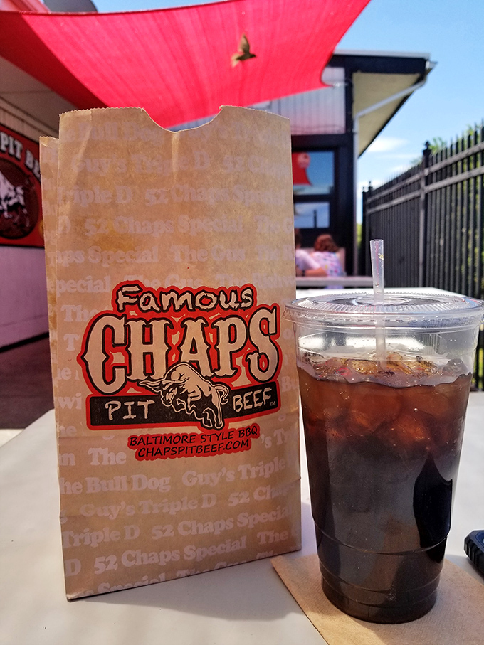 Nothing washes down smoky meat like an ice-cold root beer in a proper cup. The paper bag in the background stands ready for its meaty treasure.