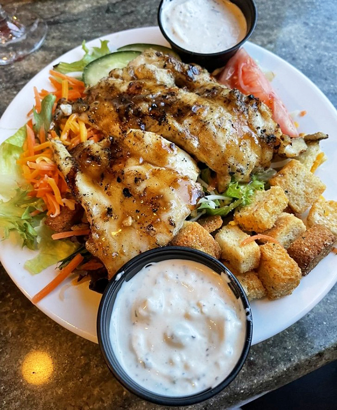 Grilled fish atop fresh greens proves that "healthy choice" and "most delicious option" aren't mutually exclusive concepts at seafood sanctuaries like this. 