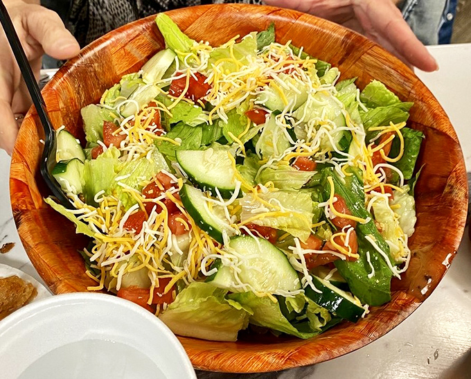 A wooden bowl of garden-fresh ingredients topped with a confetti of cheese &ndash; proof that even salads can be exciting at Boardwalk Grill.