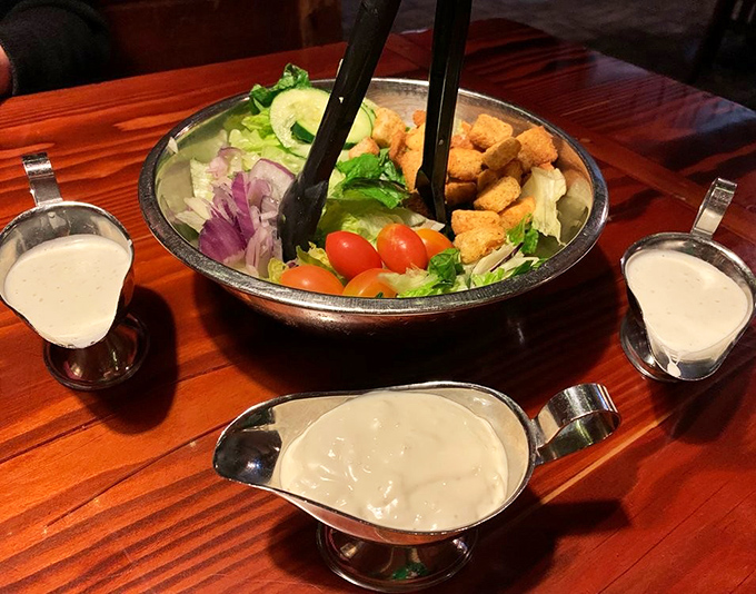 Even the salad gets the royal treatment&mdash;a metal mixing bowl of fresh greens with dressing options served in silver gravy boats, because ranch deserves respect too.