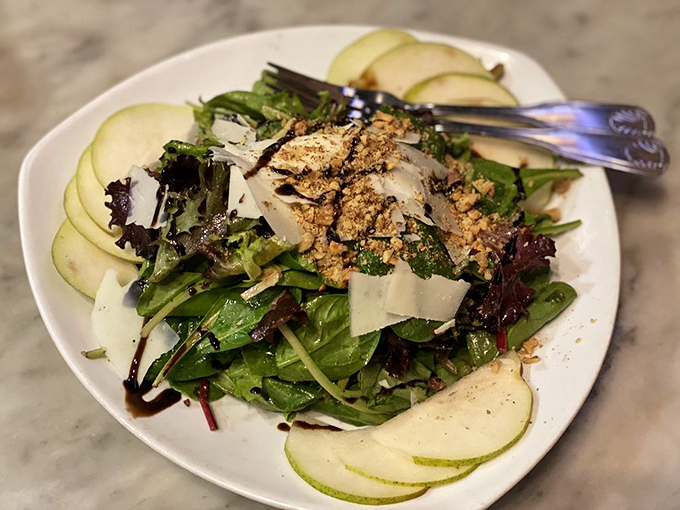This salad isn't just playing a supporting role &ndash; it's stealing the show with crisp greens, shaved pear, and a balsamic drizzle.
