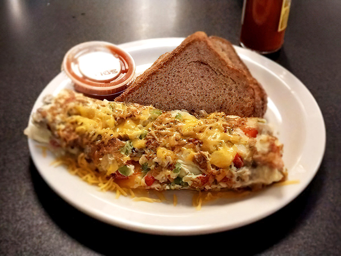 This omelet doesn't just contain ingredients; it showcases them with pride, like a delicious Texan flag of cheese, vegetables, and morning satisfaction.