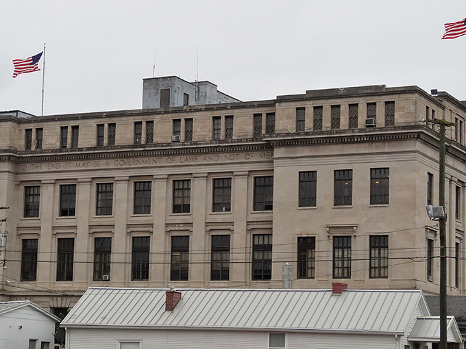 The Scioto County Courthouse commands respect with its classical stonework and bold inscription reminding citizens they're entering the domain of law.