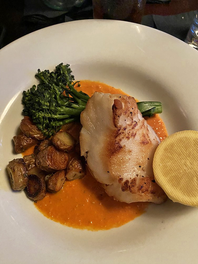 Sea bass plated with artistic precision, proving that steakhouses can nail seafood too, like a quarterback who's also great at ballet.