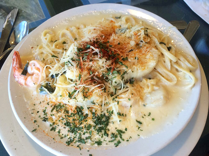 Pasta swimming in a sea of cream sauce with plump shrimp standing guard. Comfort food that got its master's degree in coastal cuisine.