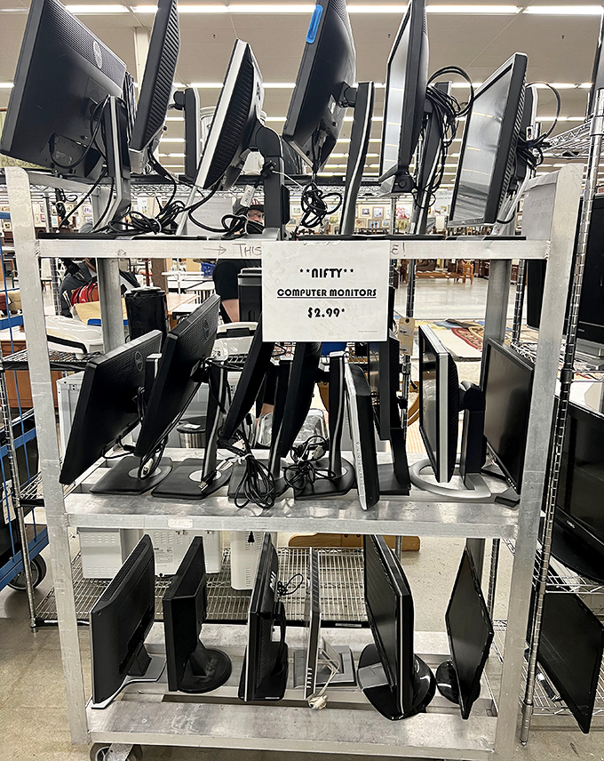 Computer monitors stacked like technological yearbooks – each screen a portal to a different digital era gone by.