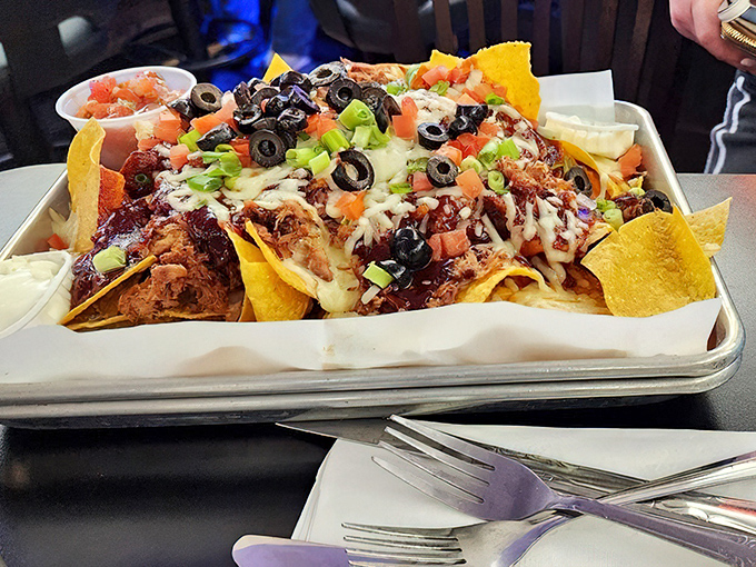 Nachos that laugh at personal portion sizes. This mountain of melted cheese, pulled pork, and toppings requires a team effort and zero shame.
