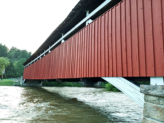 The bridge's lengthy wooden corridor stretches before you, a tunnel through time that's survived floods, storms, and countless Pennsylvania winters.