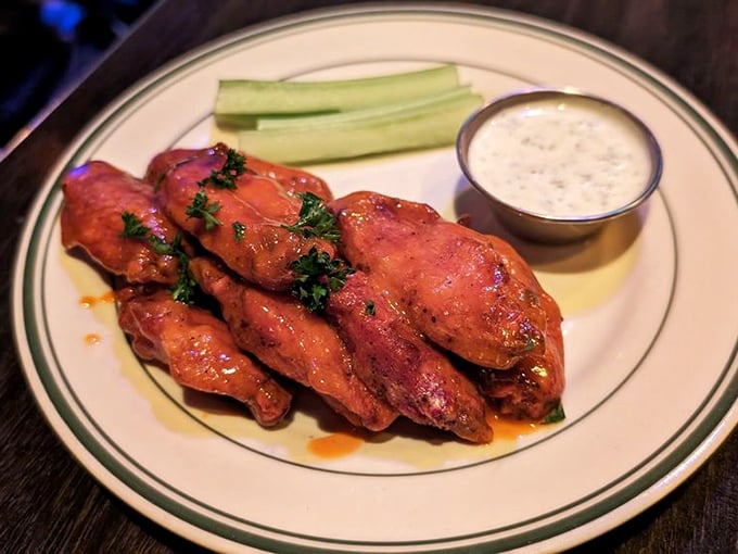 Buffalo wings done right – crispy, saucy, with cool ranch standing by for emergency heat management. The celery provides the illusion this is somehow healthy.