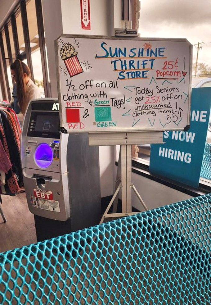 The whiteboard of wonders announces today's special discounts, proving that thrift store mathematics is the most satisfying equation: less money equals more stuff.