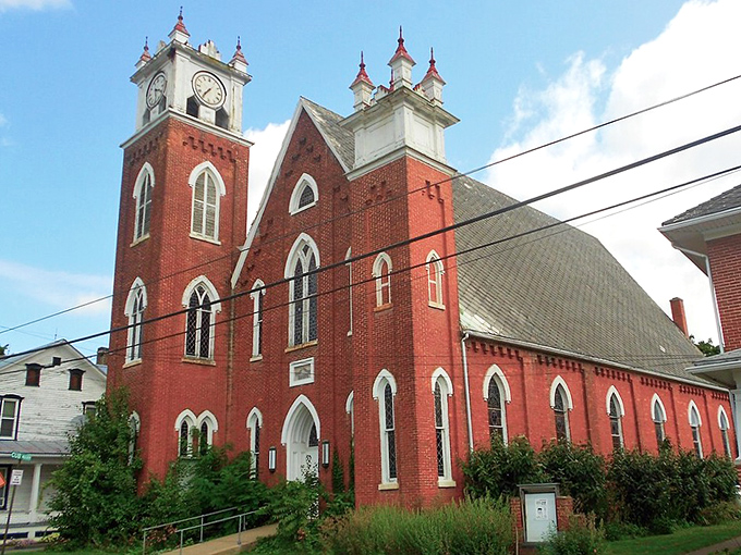 Red brick church towers pierce the sky, calling faithful souls to gather in timeless community tradition.