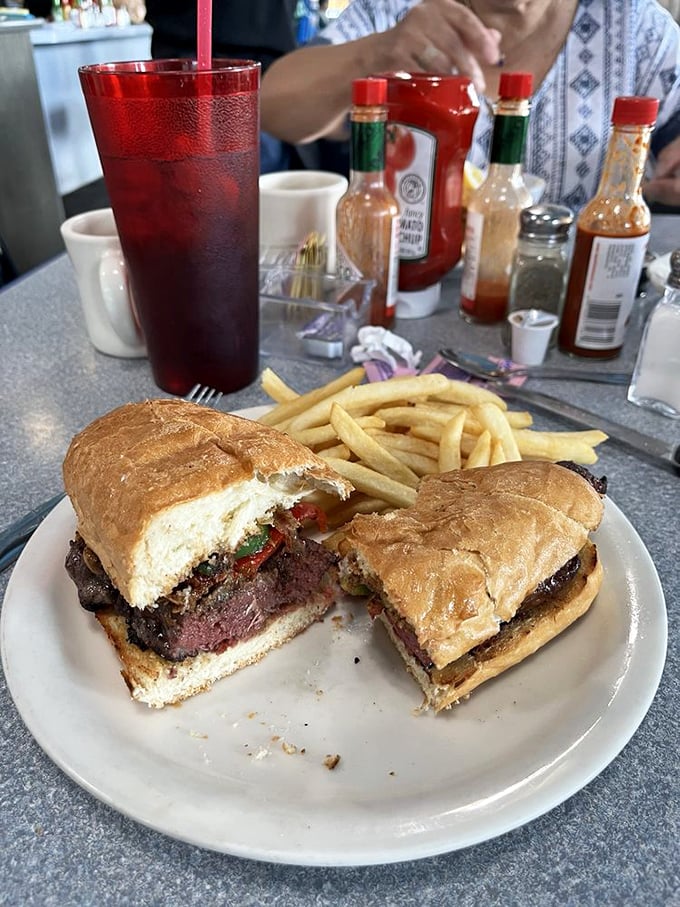 A sandwich so substantial it requires strategic attack planning. The steak inside looks like it's auditioning for a meat lover's dream sequence.